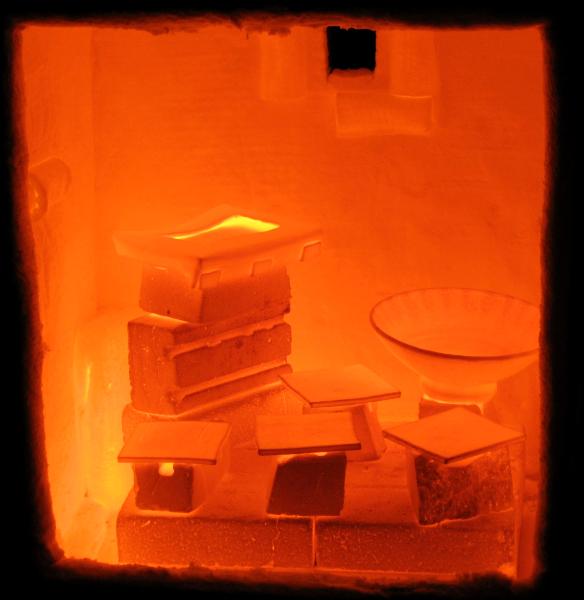 The inside of a just-opened kiln showing the pots glowing orange hot ... The inside of a just-opened kiln showing the pots glowing orange hot ...